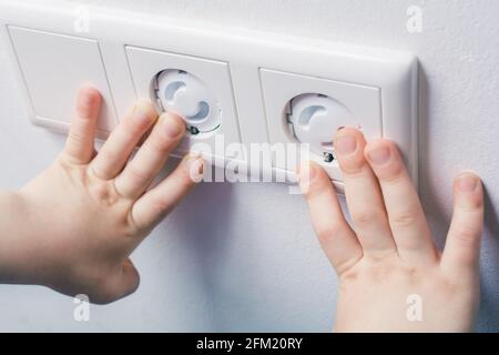 Baby Touching Electrical Outlet Stock Photo - Alamy