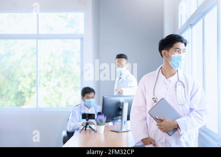 Three doctors having an online consultation with a patient Stock Photo ...