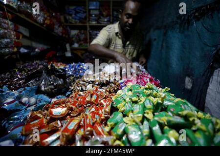 Khartoum, Sudan. 5th May, 2021. A vendor sells sweets at a market in ...