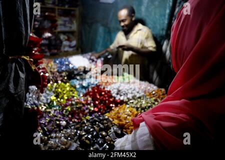 Khartoum, Sudan. 5th May, 2021. A vendor sells sweets at a market in ...