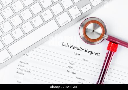 Lab results request form and sample blood in tube with stethoscope ...