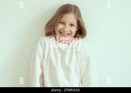 Shy beauty. Student little kid. Girl pupil on yellow background. Back ...