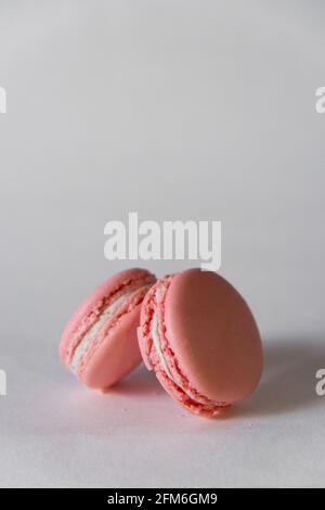 Close-up of two colorful macaroons on serviette and cake server on ...