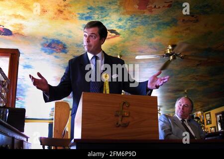 Nigel Farage (left) talking with David Bull (centre), at a Reform UK ...