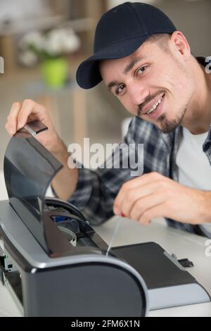 happy man fixing a printer Stock Photo - Alamy