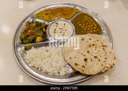 Typical Indian dish Thali. Vegetarian dishes on one large round plate ...