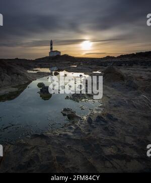 Eerie scenery of a lighthouse on the cliff in the ocean Stock Photo - Alamy