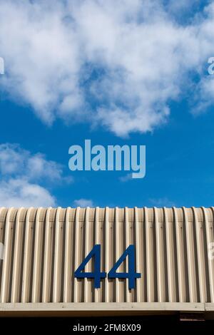 A large blue number 44 on a striped background with blue skies Stock ...