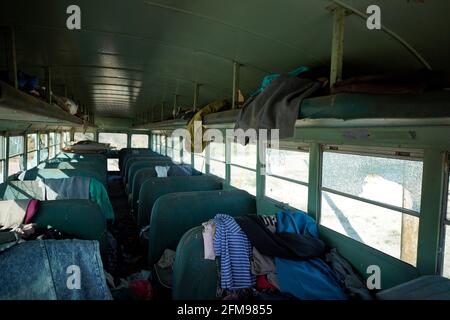 A bus filled with discarded clothes that migrants have left after ...
