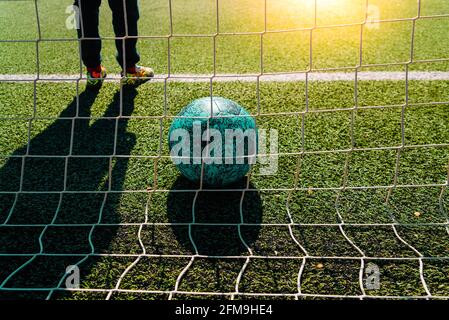 Soccer ball entering a goal defended by a goalkeeper, copy space Stock ...