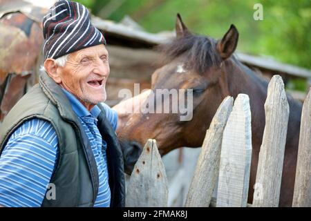 Elderly Bulgarian man with horse, Gorno Draglishte. Razlog Municipality ...