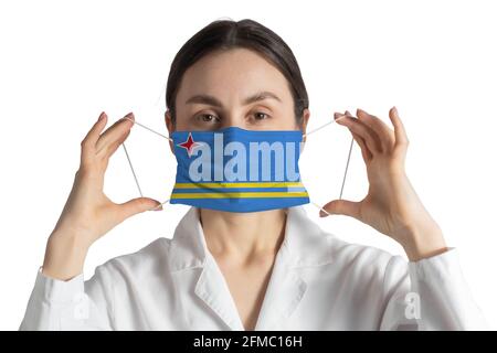 Respirator with flag of Aruba Doctor puts on medical face mask isolated ...