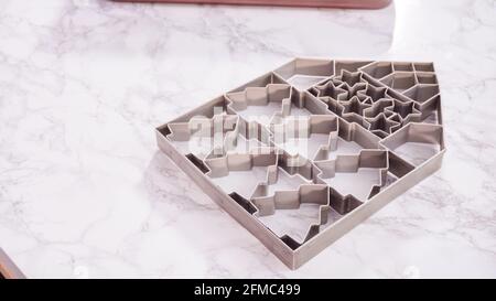 Cutting out sugar cookies with giant Christmas cookie cutter Stock ...
