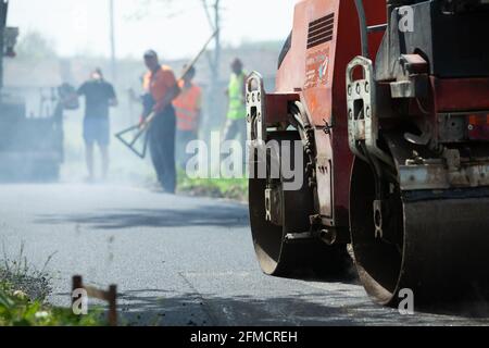 Mihaltsi, Bulgaria - May 7 2021: Workers leveling asphalt on a road ...