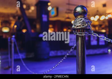 Chains dangling from poles for the delimitation of parking lots or ...