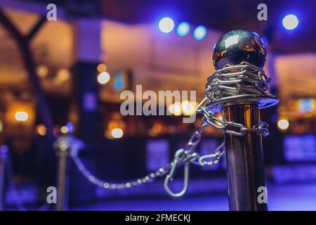 Chains dangling from poles for the delimitation of parking lots or ...