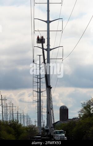 Electricity utility workers maintain power distribution lines in ...