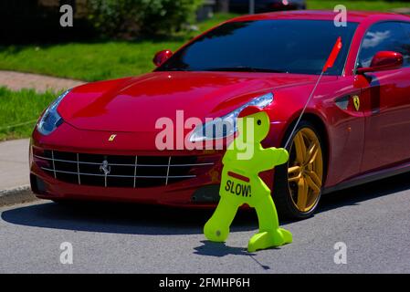 A sleek red Ferrari parked on a classic London street, juxtaposing ...