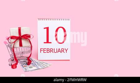 February 10th. Day 10 of month, Calendar date. Stylish roses flat lay ...