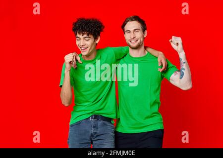 funny friends green t-shirts hugs emotions joy red background Stock ...