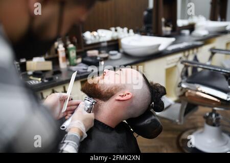 Midsection of barber cutting man beard at salon Stock Photo - Alamy