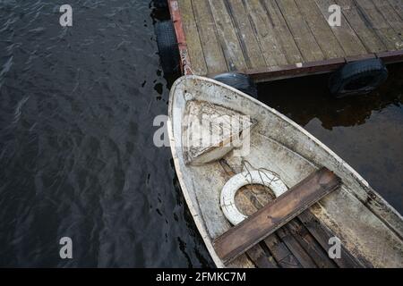 Old fishing boat parked near wooden pier Stock Photo - Alamy