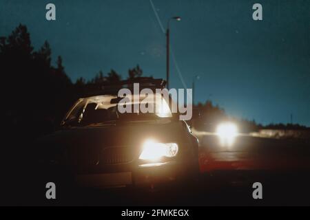 Night beam of classic car. Stop at long trip Stock Photo - Alamy