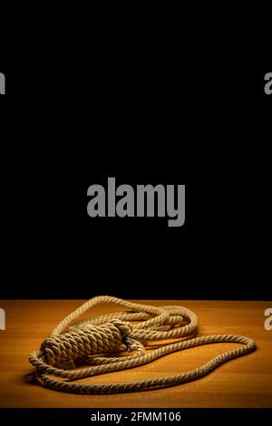 suicide concept. noose with shadow on dark wall background Stock Photo ...