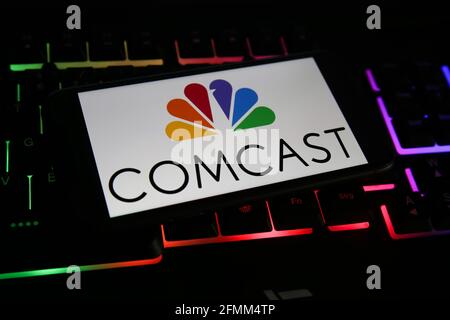 Comcast logo on mobile phone , background is a keyboard , Sydney ...