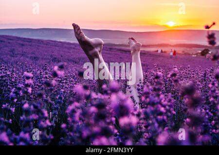 Selective focus. Slender ballerina girl legs in lavender bushes, warm ...