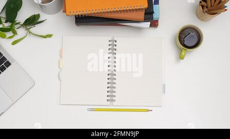a stack of books and a cup with pencils Stock Photo - Alamy