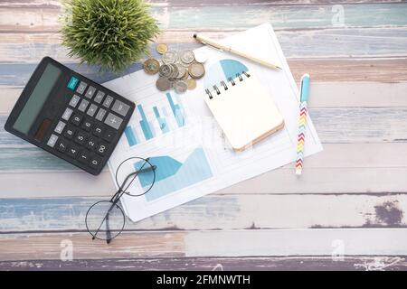 financial graph, calculator and notepad on table Stock Photo - Alamy