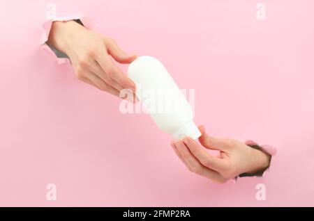 female hands hold sunblock bottle with copy space Stock Photo - Alamy