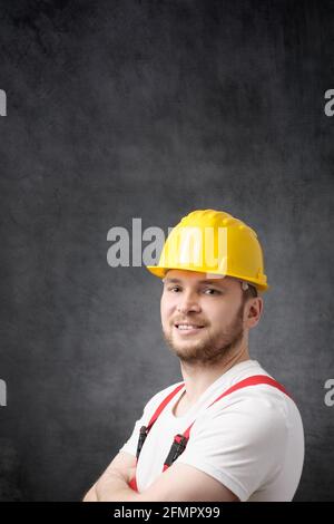 Smiling maintenance male worker looking at camera, while keeping broom ...