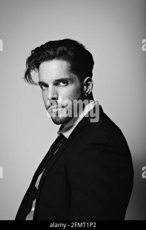 Grayscale shot of a handsome guy posing chained up Stock Photo - Alamy