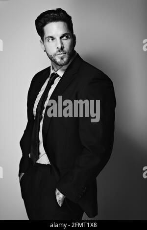 Grayscale shot of a handsome guy posing chained up Stock Photo - Alamy