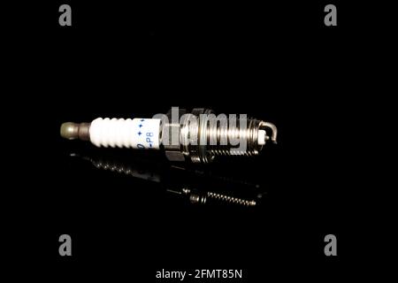 A new single spark plug for a petrol combustion engine Stock Photo - Alamy