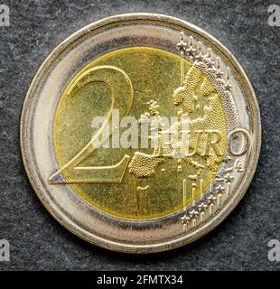 Common side of two euro coin isolated on a black background. The ...