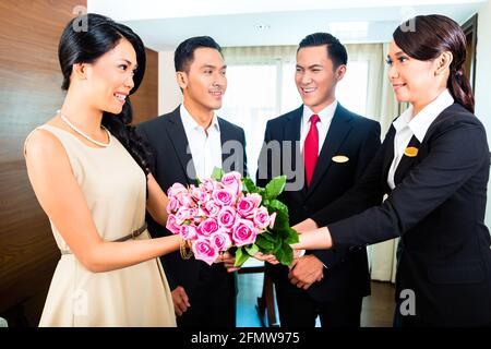 Staff greeting guests in hotel Stock Photo - Alamy
