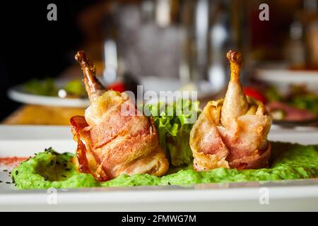 Quail mousse in bacon and broccoli puree. Close-up, selective focus ...