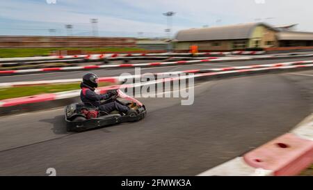 A panning shot of a racing kart as it circuits a track Stock Photo - Alamy
