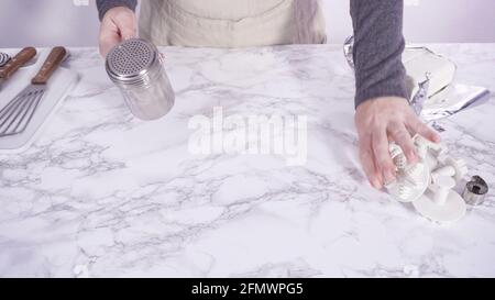 Step by step. Cutting out snowflakes with cookie cutters out of white ...