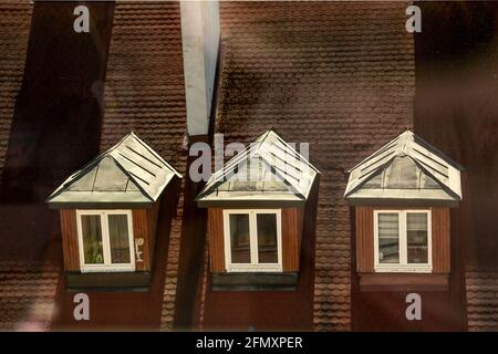 Windows of attic roof, classic architectural design of old town with ...