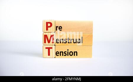 Medical and PMT, premenstrual tension symbol. Wooden block with the ...