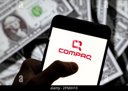 In this photo illustration a Compaq logo seen displayed on a smartphone ...