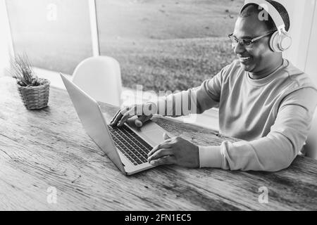 Hispanic senior man wearing call center agent headset at night with a ...