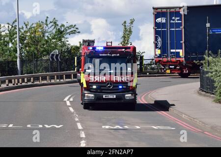 London Fire Brigade fire engine responding to an emergency call in ...