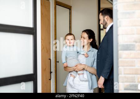 husband waving goodbye to his family before going to work Stock Photo ...