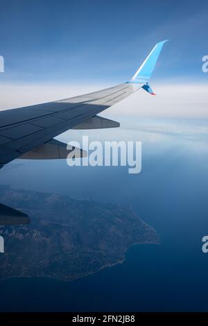 Airplane wing flying above greek town Stock Photo - Alamy