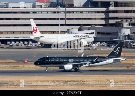 Airbus A320-214 airliner with Starflyer airlines passes a JAL Boeing ...